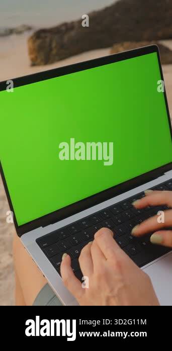 Vertical video. Close up of Hands Typing on Laptop with Green Screen on ...