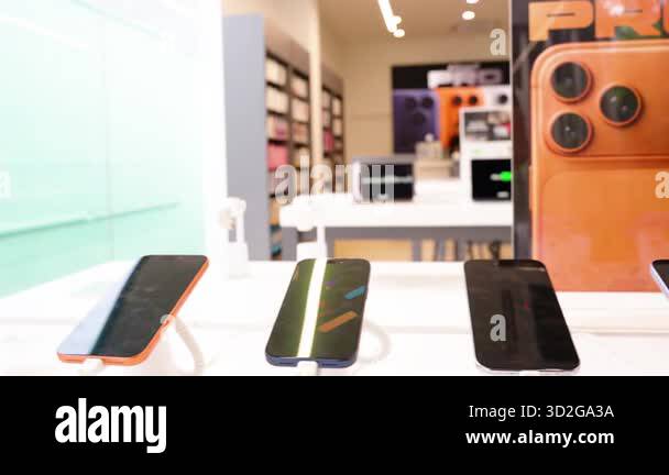 Close View of Multiple Smartphones on Display Stand with Large Poster ...
