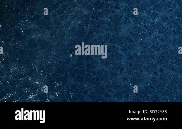 Macro timelapse of ice frost forming and spreading on a dark surface ...