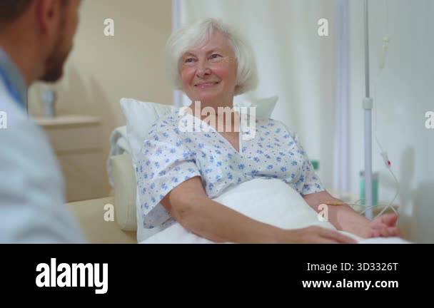 In the private hospital office old caucasian positive woman ...