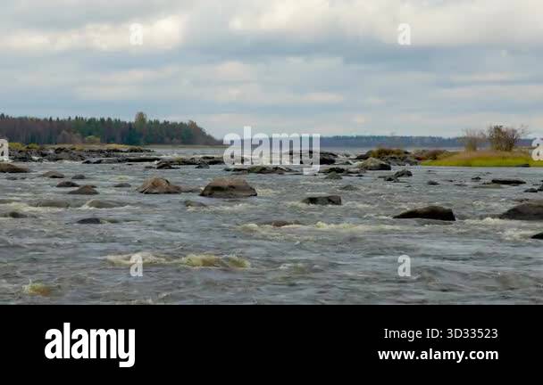 Dynamic river footage with flowing water and rocks under dramatic ...