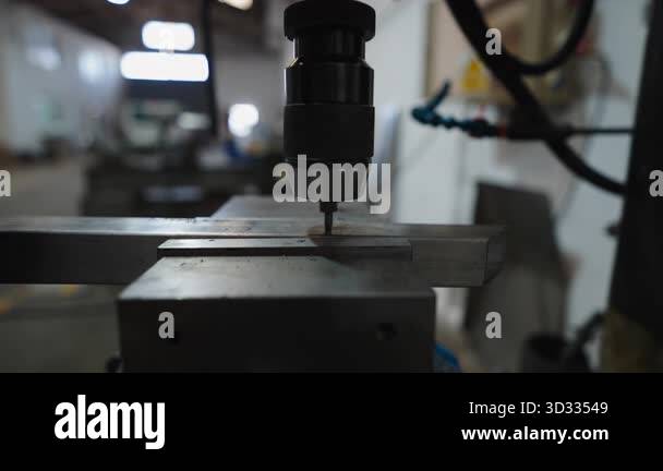 Close-up of a drill making a hole in a metal bar in a workshop - 4K ...