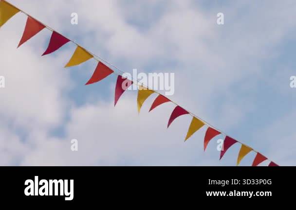 Experience the vibrant display of colorful triangular flags fluttering ...