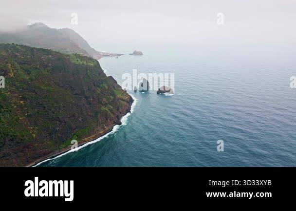 Beautiful green shoreline washed by deep blue ocean water in super slow ...