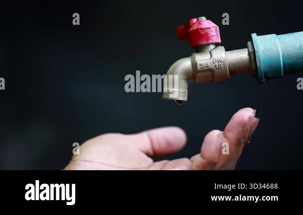 hand holding a water tap Stock Video Footage - Alamy