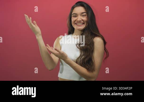 Smiling young hispanic woman showing open hands gesture with relaxed ...