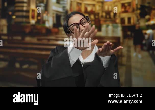Smiling woman in judge uniform making money gesture inside church ...