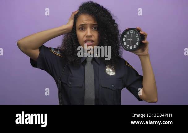 Woman police officer holding clock against purple background showing ...