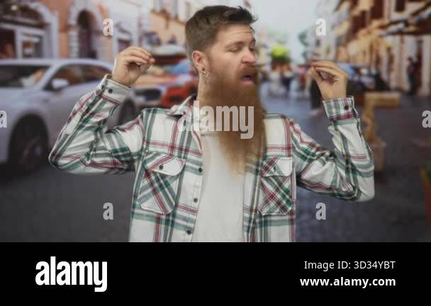 Man gestures with entwined fingertips and animated hands on busy city ...