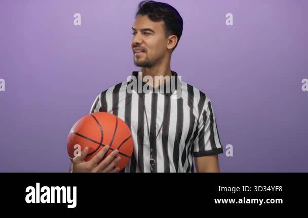 Young hispanic man wearing referee uniform holding basketball, smiling ...