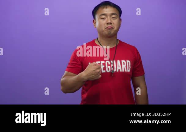 Man lifeguard points finger to chest showing lifeguard shirt label and ...