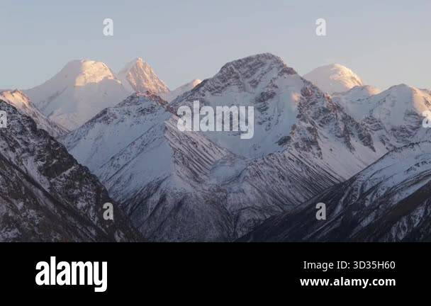 Majestic snow-capped mountains are captured in a dynamic sequence ...