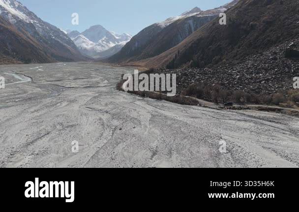 Scenic mountain valley features a winding river flowing through rocky ...
