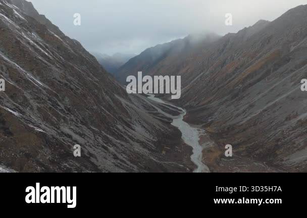 Aerial view captures the winding river flowing through a rugged ...