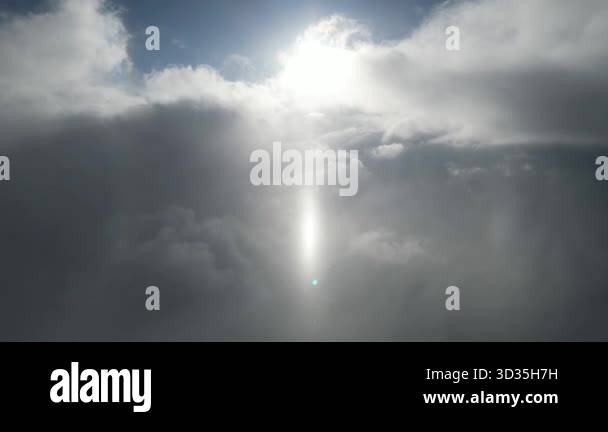 Ethereal sunlight breaks through thick clouds, illuminating the scene ...