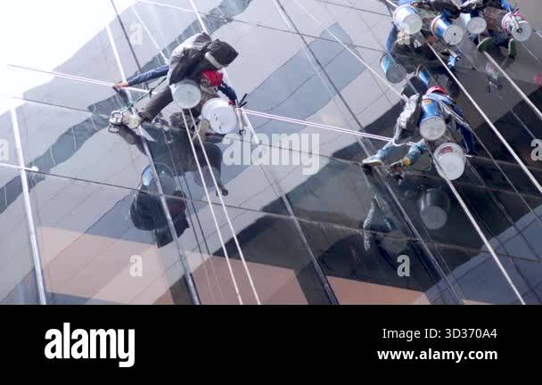 Team of window washers cleaning a tall building Stock Video Footage - Alamy
