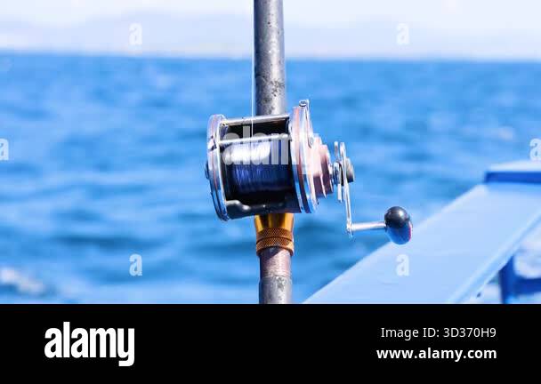 Close-up of a fishing rod on a boat in Phuket, Thailand. Bright ...