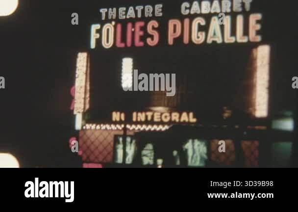 A vibrant neon sign for the Folies Pigalle theatre cabaret glows at ...