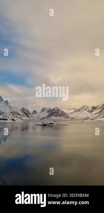 Beautiful scenery of snow mountains and gold sky reflected on the lake ...