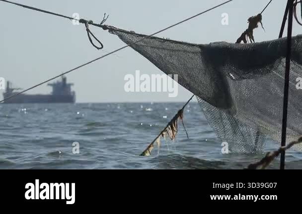 Among summer ocean (sea) to dry nets for fishing, on wooden poles ...