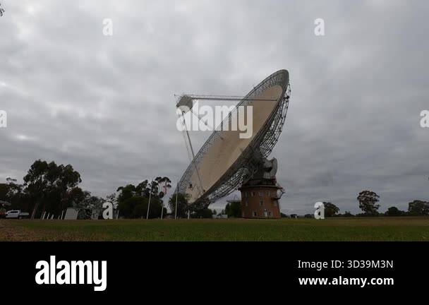 Time-lapse of a satellite dish rotating under cloudy skies Stock Video ...