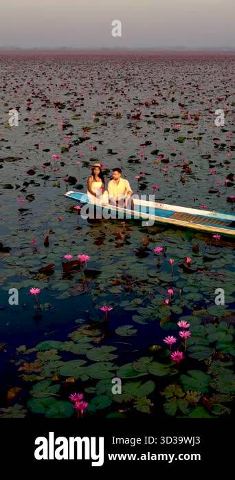Experience a tranquil moment as a couple enjoys a serene boat ride ...