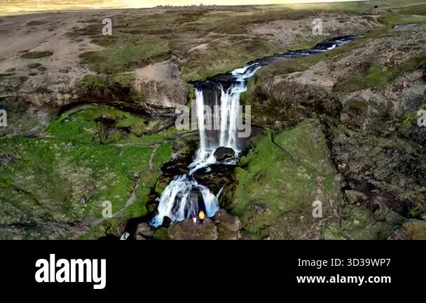 Grundarfoss waterfall in Iceland cascades elegantly down rocky cliffs ...