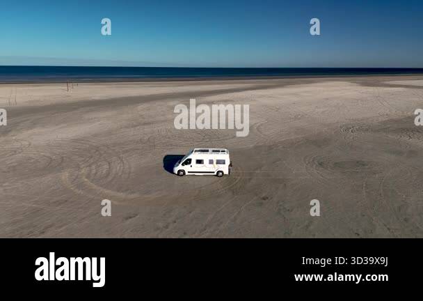 A serene view of Lakolk Strand beach in Romo, Denmark featuring a white ...