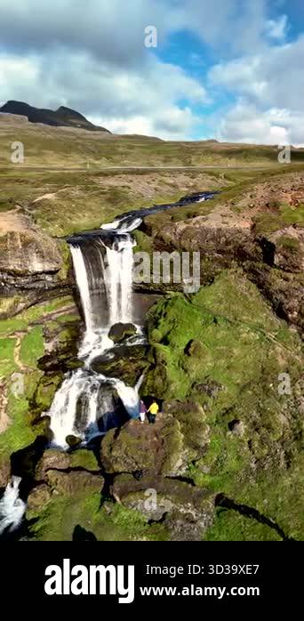 Grundarfoss waterfall captivates with its stunning cascade surrounded ...
