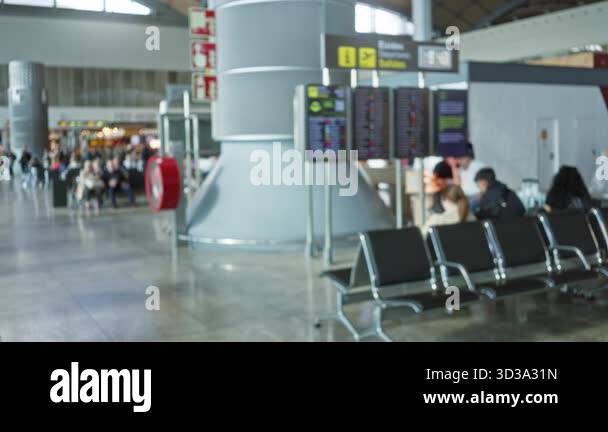 Blurred people waiting in the busy airport terminal with flight ...
