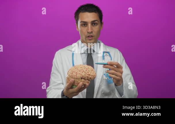 Young hispanic male doctor in uniform holding brain model with ...