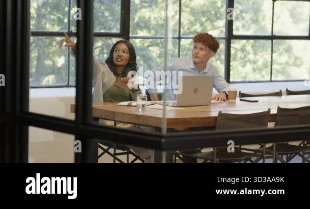 Collaborating at office table, diverse colleagues discussing project ...