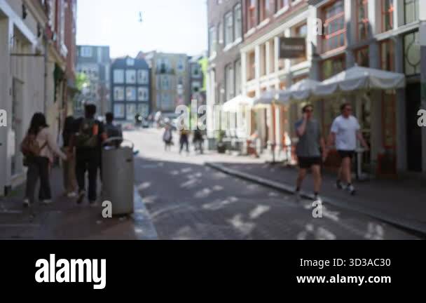 Blurry city scene in a sunny european street with out-of-focus ...