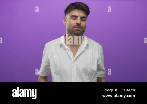 Hispanic man pointing finger to temple in studio setting wearing white ...