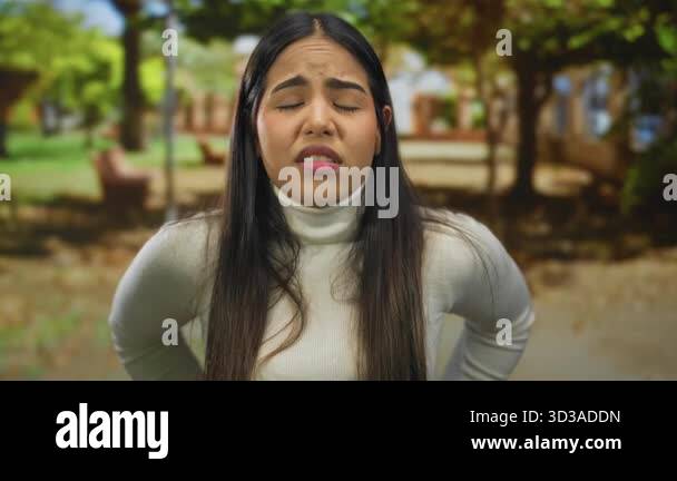 Woman face shows confused look in park with young latin hispanic attire ...