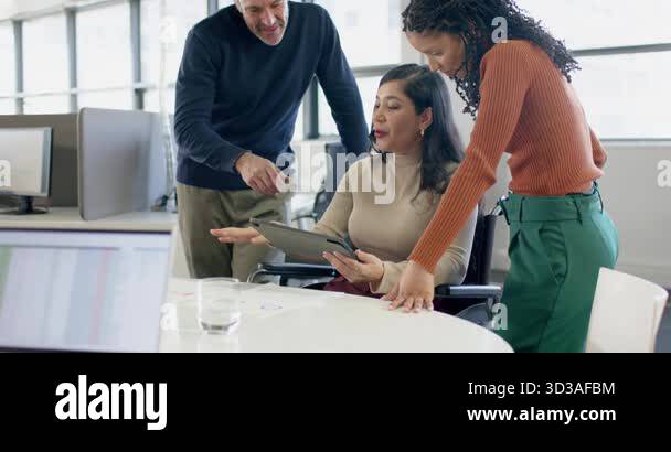 Responding to tablet tap, diverse team leaning on round table, pointing ...