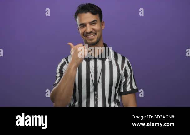 Young hispanic man referee giving a thumbs-up with a smile against an ...