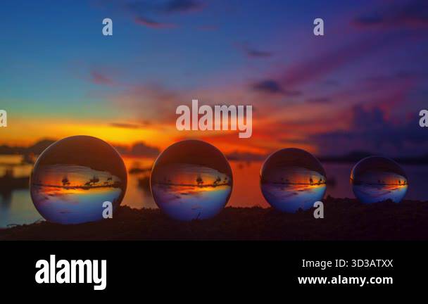 Three glass spheres reflecting sunset colors Stock Video Footage - Alamy