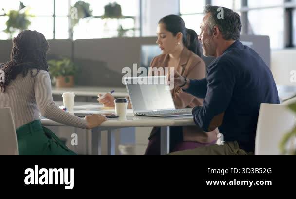 Diverse coworkers exchanging graphs, typing notes, reviewing charts at ...