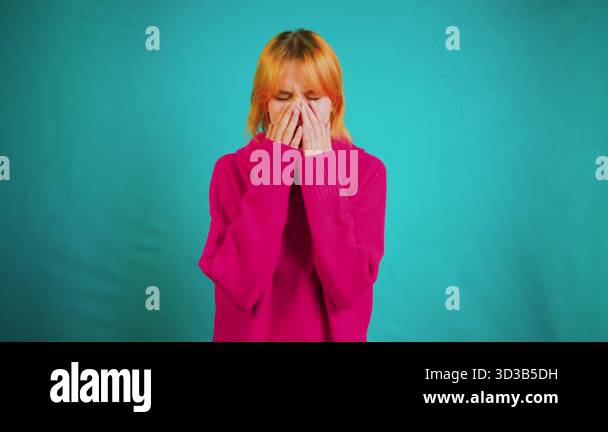 Unhappy young woman with dyed hair crying and covering her face with ...