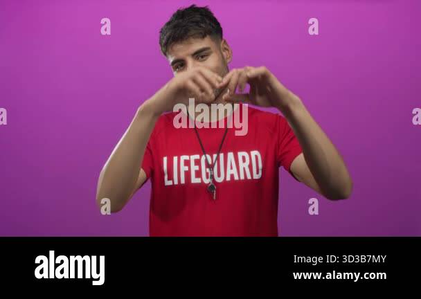 Young hispanic lifeguard man wearing red shirt makes heart gesture with ...