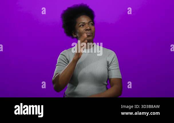 Woman pondering isolated against vibrant purple background looking ...