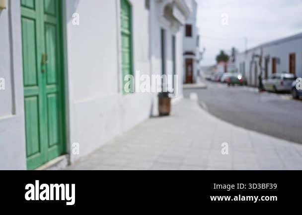 Outdoor street scene in lanzarote, spain with green doors, white ...