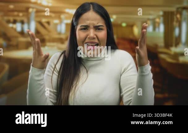 Woman expressing frustration in a restaurant setting, showcasing ...