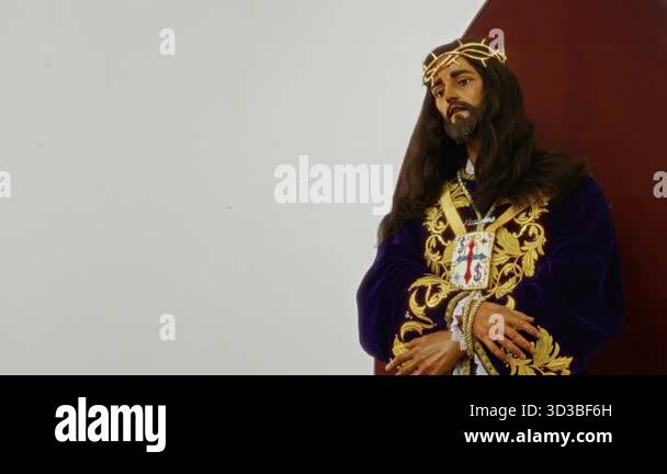 Statue of jesus adorned in intricate purple robe inside church with ...