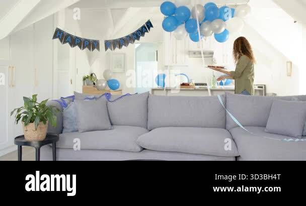 Birthday setup inspiring mature woman arranging cupcakes, cake on ...
