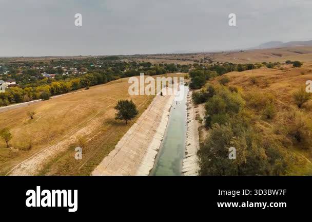 Aerial drone view panorama of the field near road and big irrigation ...
