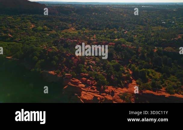 Red clay rocks covered with some vegetation. Drone footage above the ...