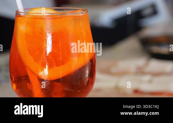 Chilled spritz cocktail with ice, accompanied by appetizer bowl ...