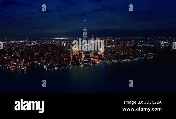 Rising over the calm waterscape of the East River at night. Revealing ...